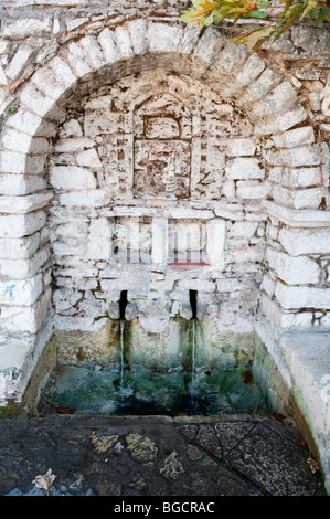 Greek water fountain with bright drinking water Stock Photo - Alamy