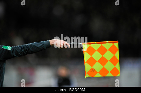 The linesman holds the offside flag Stock Photo - Alamy