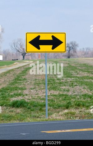 Road sign with two arrows pointing down to opposite sides Stock Photo ...