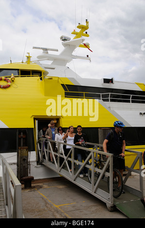 Passengers disembark from a high speed commuter ferry at Ryde Pier Isle ...