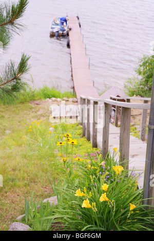 Wooden ramp leading to fishing boat and boat dock on fishing lake ...