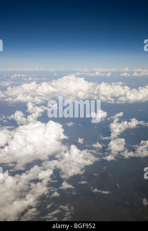View of the Earth from the airplane flying above the clouds at high ...