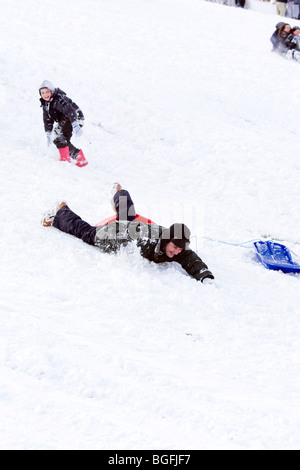 Man falling off a sledge Stock Photo - Alamy