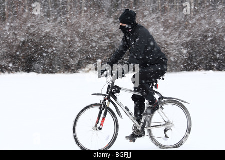 A biker riding through heavy snowfall. Katowice, Poland Stock Photo - Alamy