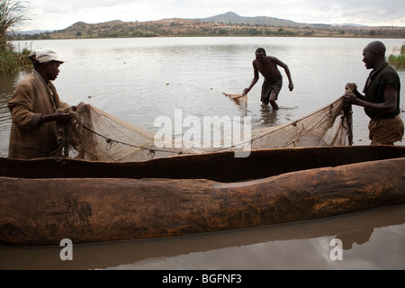 Tribal fishermen catch fish with fishing nets in the creek. Tribals ...
