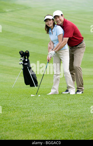 Golf coach teaching playing golf Stock Photo - Alamy