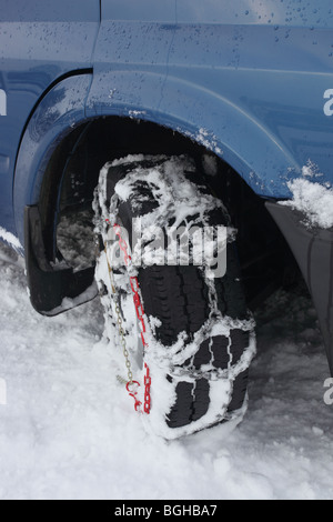 snow chains on a vehicle tire, snow chain obligation in winter snow ...
