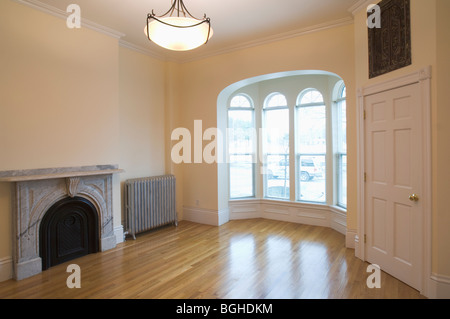 Empty room with wood floor 2 bay windows and inglenook fireplace dark ...
