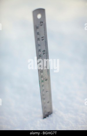 ruler measuring the depth of snow after a heavy snowfall Stock Photo ...
