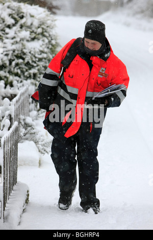 A Royal Mail Post woman battling through the winter snow to make her ...