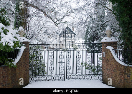 Snow-covered iron gates. winter wrought fence gates Stock Photo: 221512381 - Alamy