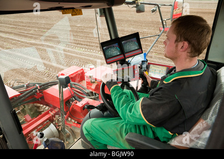 Cab interior of a potato harvester showing computer and monitor screens ...