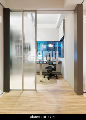 Home office with glass sliding door on to balcony Stock Photo - Alamy
