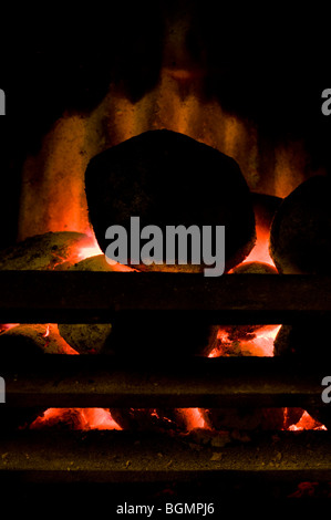 Smokeless coal burning in a grate of a domestic home in a smokeless ...