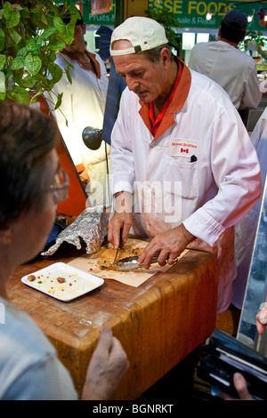 People sampling meat products at the St. Lawrence Market, Toronto ...