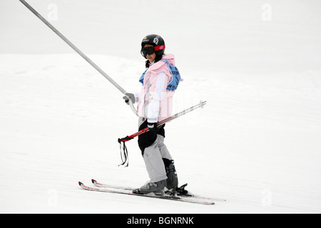 Skier on button lift on a ski slope Stock Photo - Alamy