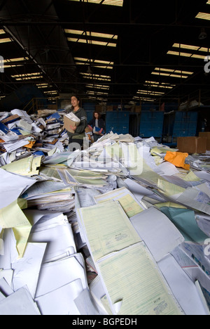 Manual sorting of different types of waste paper before the recycling ...