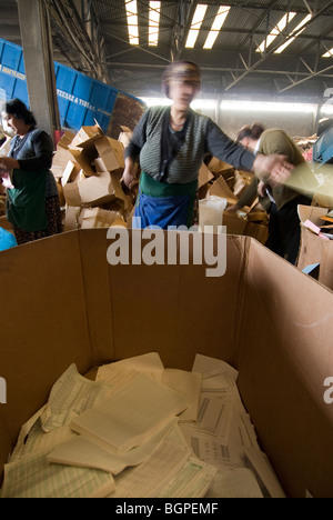 Manual sorting of different types of waste paper before the recycling ...