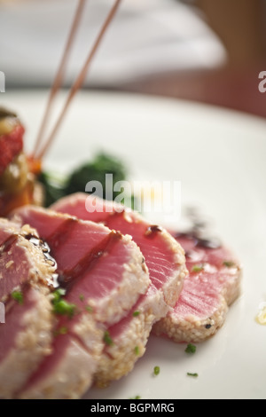 Seared tuna steak with white rice and green peas Stock Photo - Alamy