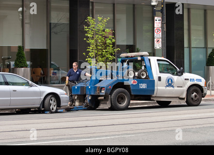 CAA worker towing a car, Toronto, Canada Stock Photo - Alamy