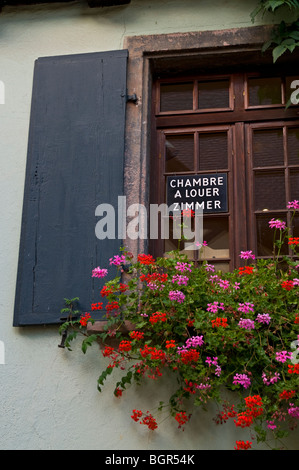 A sign advertising a Gite for rent by Gites De France mounted on a wall ...