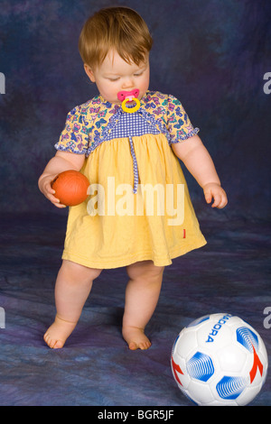 Cute Baby Boy With A Funny Yellow Hat And A Winter Jacket At The ...