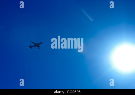 Airliner flying into the sun Stock Photo - Alamy