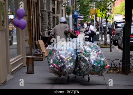 Homeless man in NYC collecting cans to take to recycle and get money in ...