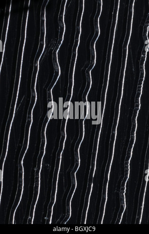 The grooves on a 45RPM stereo single vinyl record photographed at 25x ...