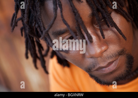 Africa Mozambique Maputo Portrait of young boy playing with volleyball ...