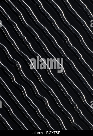 The grooves on a 45RPM stereo single vinyl record photographed at 25x ...