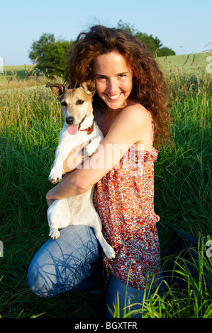 Dog in field looking at camera Stock Photo - Alamy