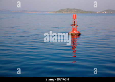 Red buoy with solar panels and red light floating in the Caribbean Sea ...