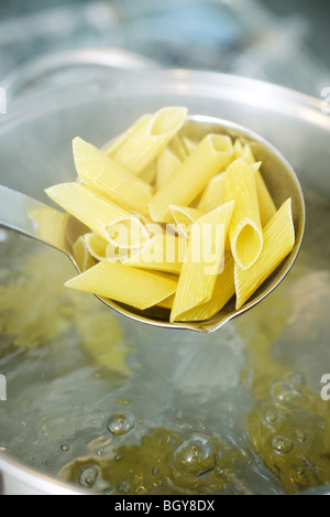 boiling penne in steel pot closeup, wide photo Stock Photo - Alamy