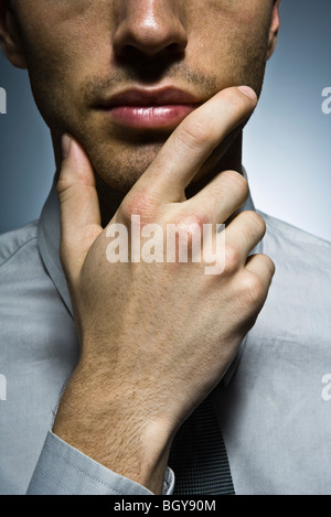 Man with hand under chin, portrait Stock Photo: 12871359 - Alamy