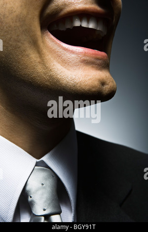cropped shot of businessman with opened mouth in suit holding doner ...
