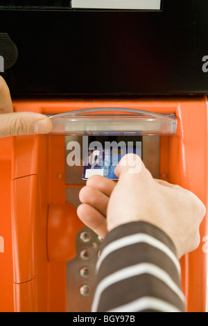 Cropped image of hand inserting credit card in ATM machine Stock Photo ...