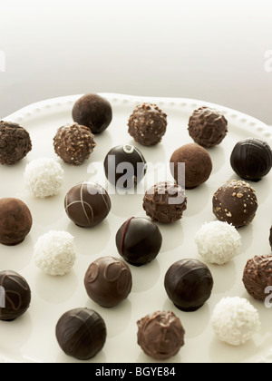A vertical high-angle view of trays of colorful macarons displayed on a ...