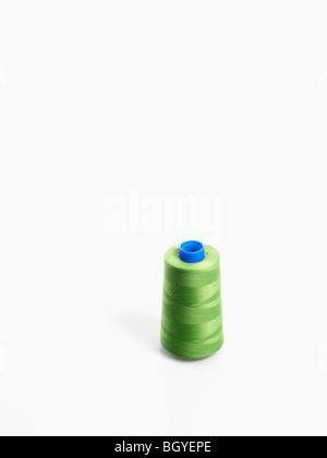 One single green thread spool with needle on white background Stock ...