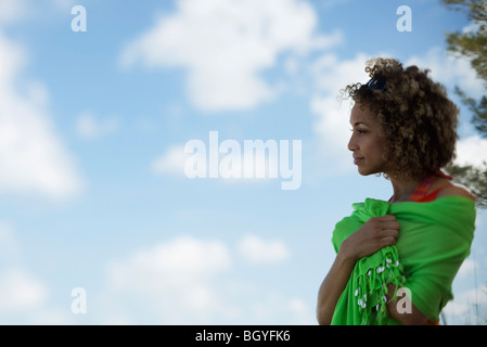 Woman standing with her arms wrapped around her torso Stock Photo - Alamy