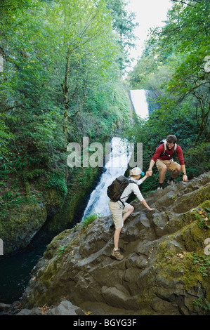 Man in front of large waterfall, Skogafoss, South Iceland, Iceland ...