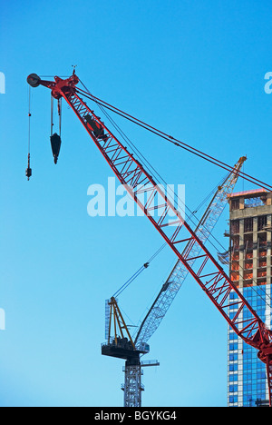 Color image of some cranes building a new structure Stock Photo - Alamy