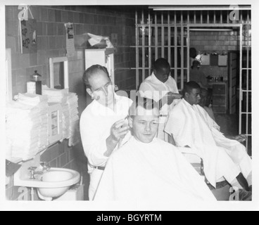 Inmate giving a member of the staff a haircut. Metal scissors and ...