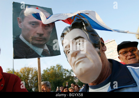 A Bosnian Serb shows a mask featuring the face of Bosnian Serb wartime ...