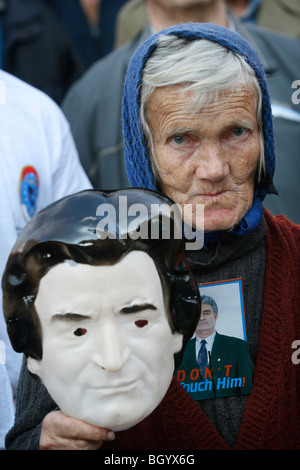 A Bosnian Serb shows a mask featuring the face of Bosnian Serb wartime ...