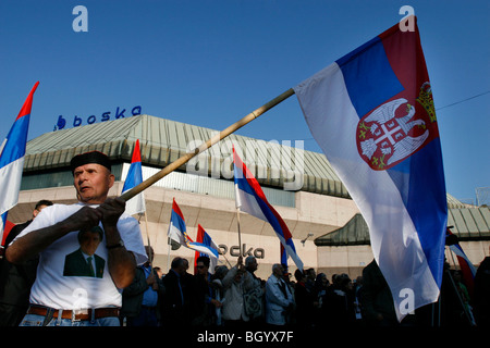 A Bosnian Serb shows a mask featuring the face of Bosnian Serb wartime ...