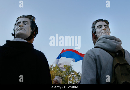 A Bosnian Serb shows a mask featuring the face of Bosnian Serb wartime ...