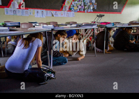 Child hiding under table in fear Stock Photo - Alamy