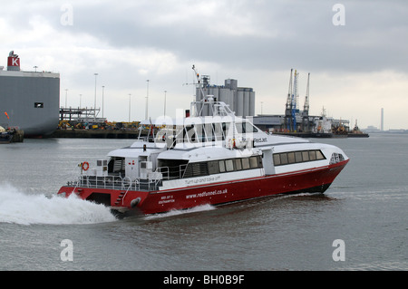 Red Jet 5 a passenger fastcat vessel passing Queen Elisabeth II ...