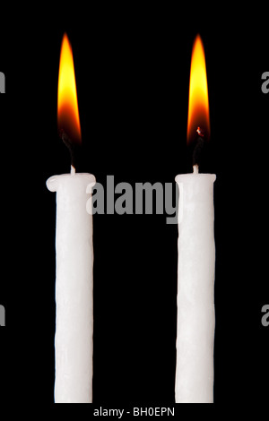 White candles isolated on a black background Stock Photo - Alamy